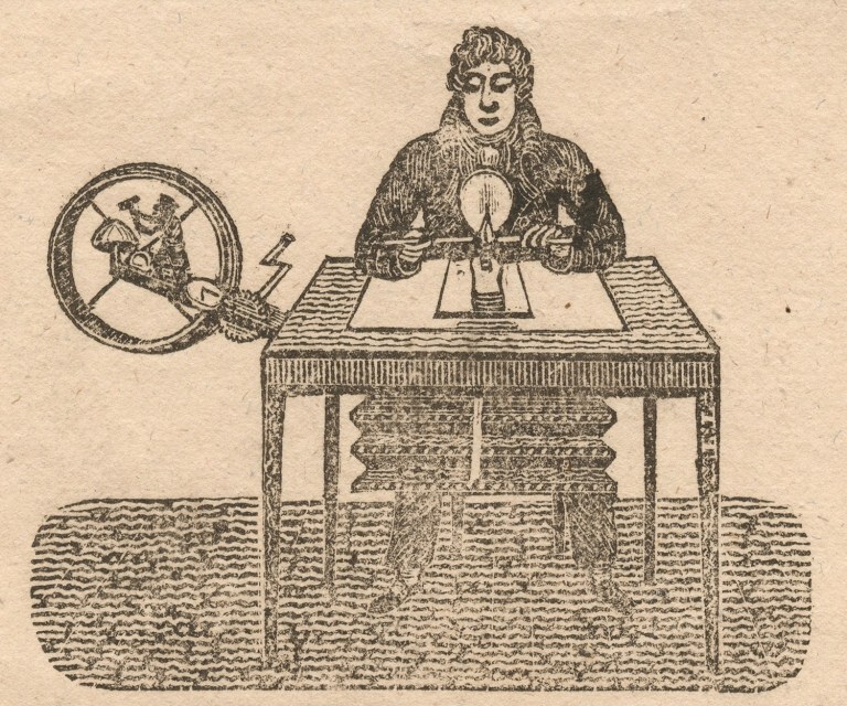 Mr. Hermann demonstrates flameworking. The wheel on the left is for ...